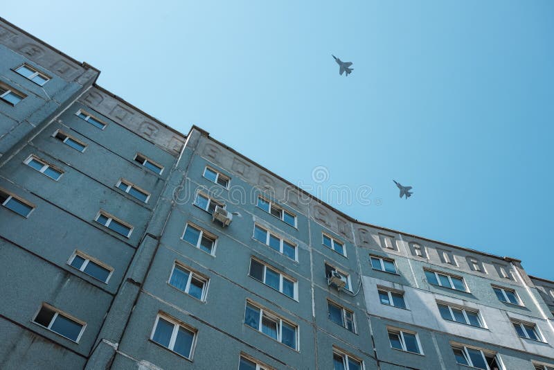 Two Military Planes Flying Overhead and Over a House in the Blue Sky ...