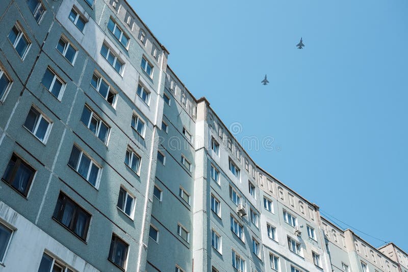 Two Military Planes Flying Overhead and Over a House in the Blue Sky ...