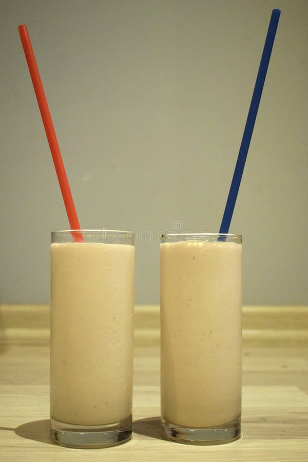 Two Milkshakes on the Background of Blue Wall Stock Photo - Image of ...
