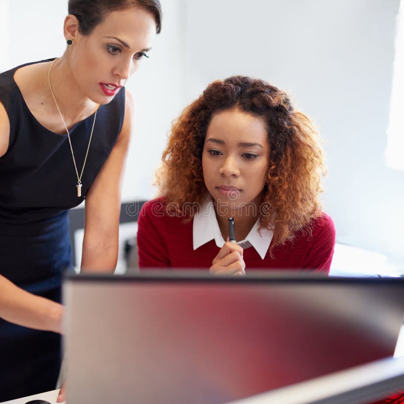 Two Minds on the Design. Two Attractive Designers at Work on a Computer ...