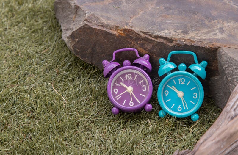 Two Mini Alarm Clock Front of Huge Stone on Grass Background Stock ...