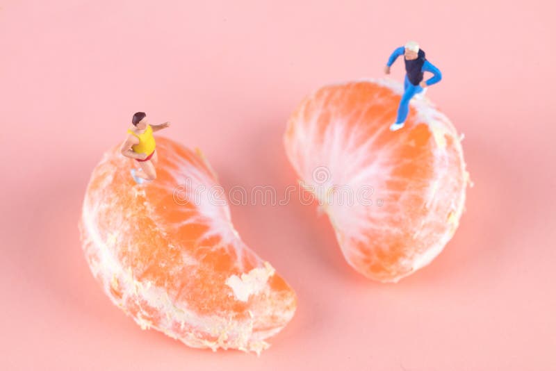 Two Miniature Figures in the Miniature World Run and Exercise on Two ...
