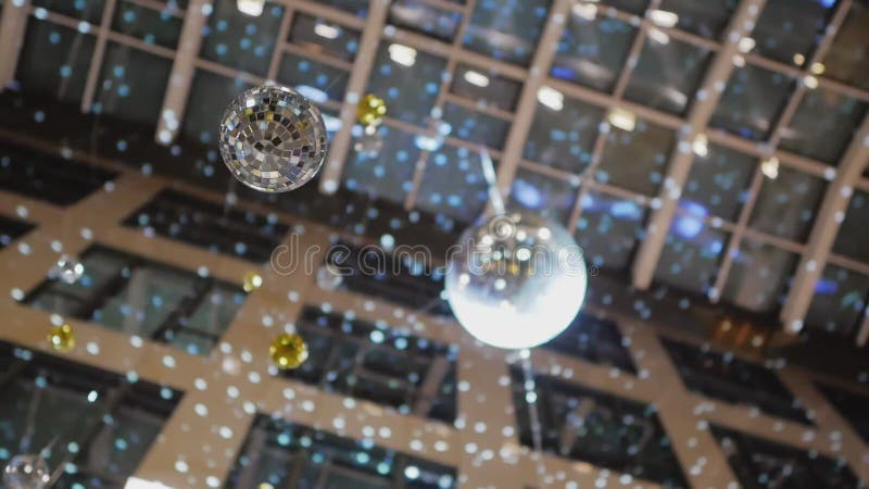 Two Mirrored Disco Balls are Suspended from the Ceiling Inside a High ...