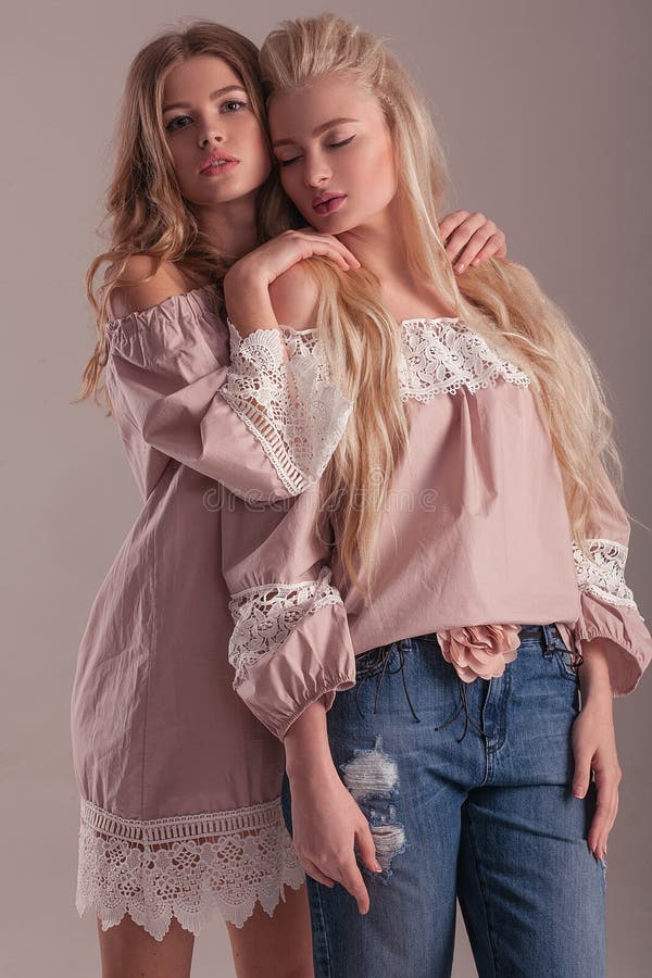 Two Models in Transparent Dresses Posing on Pink Background. Stock ...