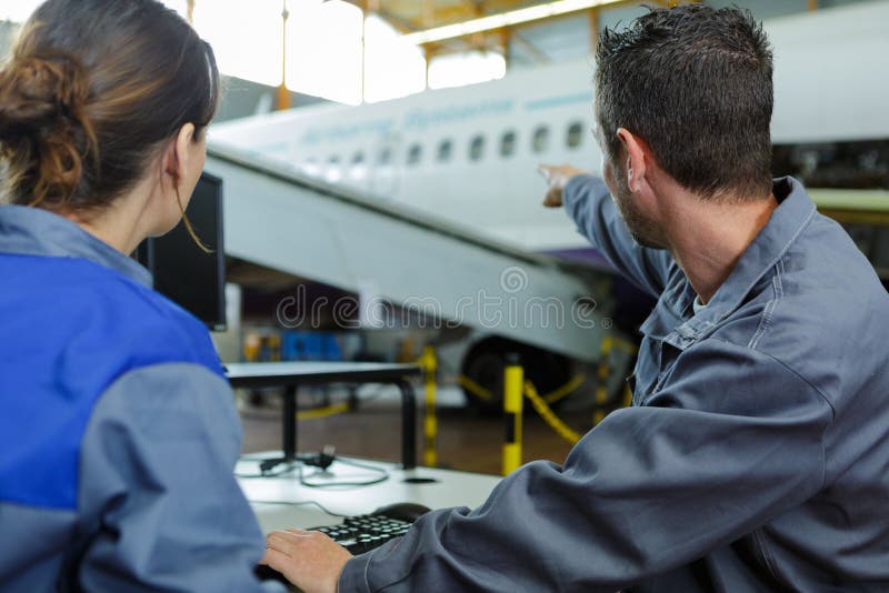 Two Modern Aircraft Engineers Pointing Airplane Stock Photo - Image of ...