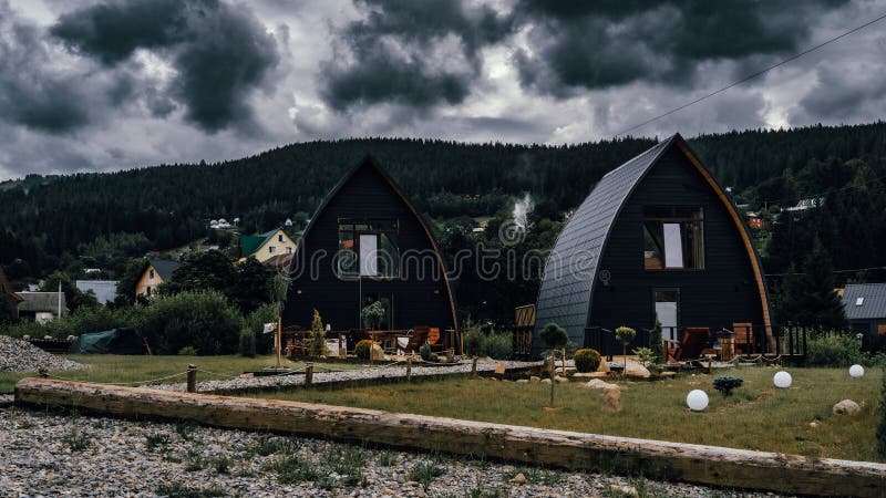 Two Modern a-frame Cabins Sit Side by Side Under a Dramatic, Stormy Sky ...