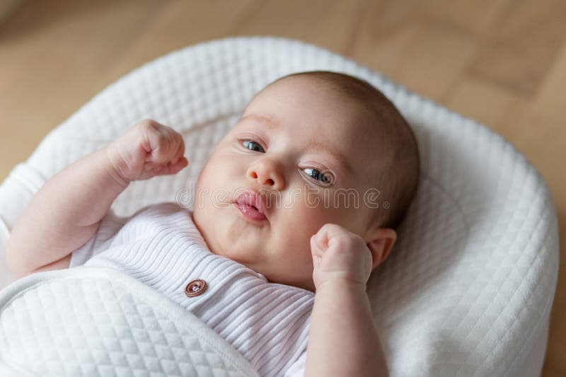 A Two-month-old Baby Rests in a Soft White Ergonomic Cocoon. Close Up ...