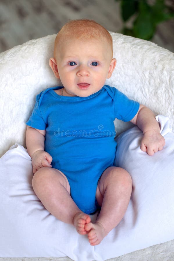A Two-month-old Baby Sits in a Chair Stock Photo - Image of male, white ...