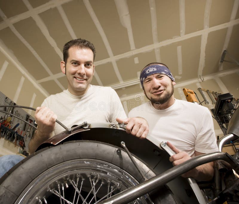 Two Motorcycle Mechanics Placing Fender Stock Photos - Free & Royalty ...