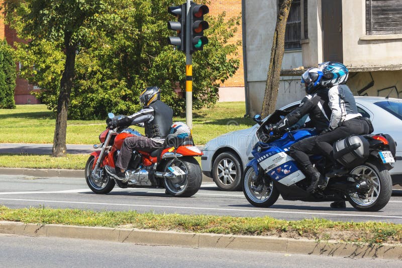 Two Motorcyclists Waiting at a Traffic Light on a Sunny Day Editorial ...
