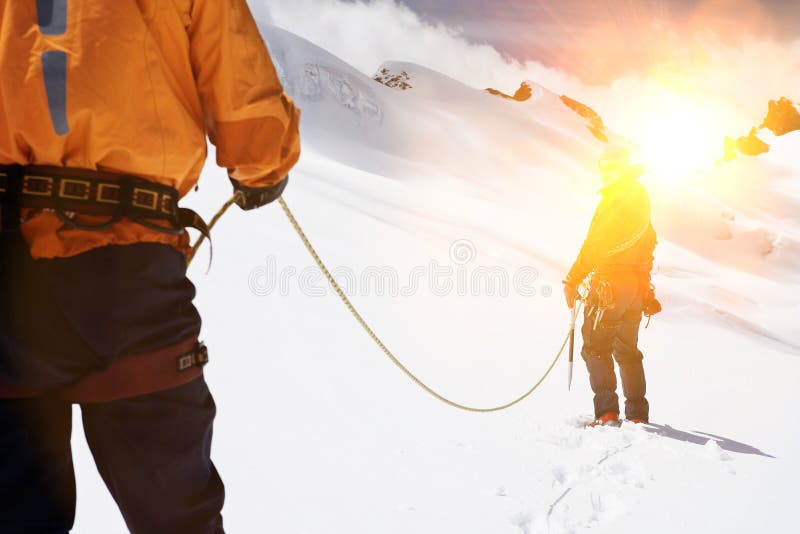 Two Mountaineers Hiking in Mountains Holding Ropes Stock Image - Image ...