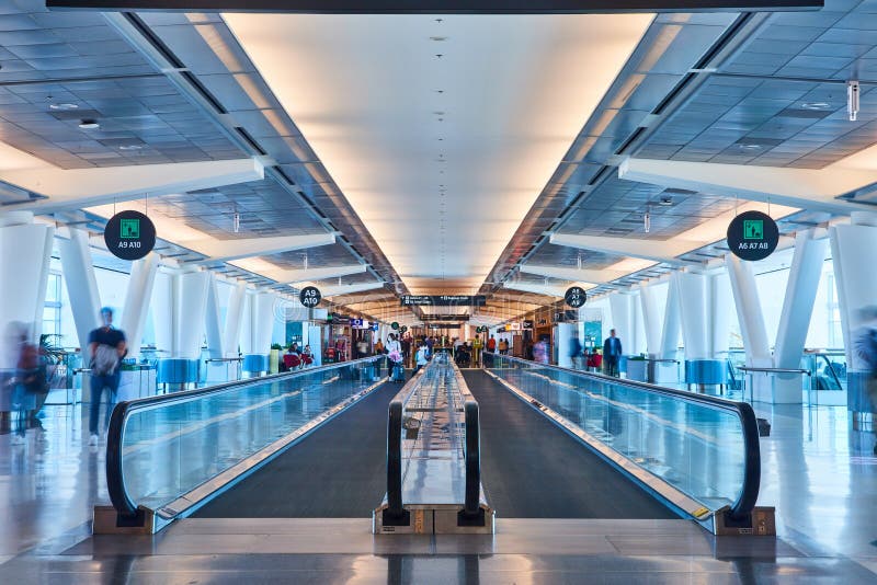 Two Moving Walkways Side by Side with People Stepping on Far End in ...