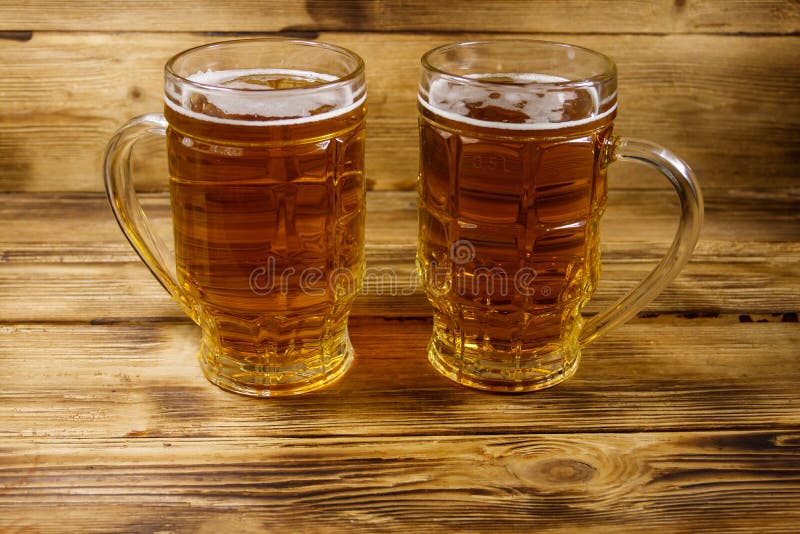 Two Mugs of Beer on Wooden Table. Top View Stock Image - Image of beer ...
