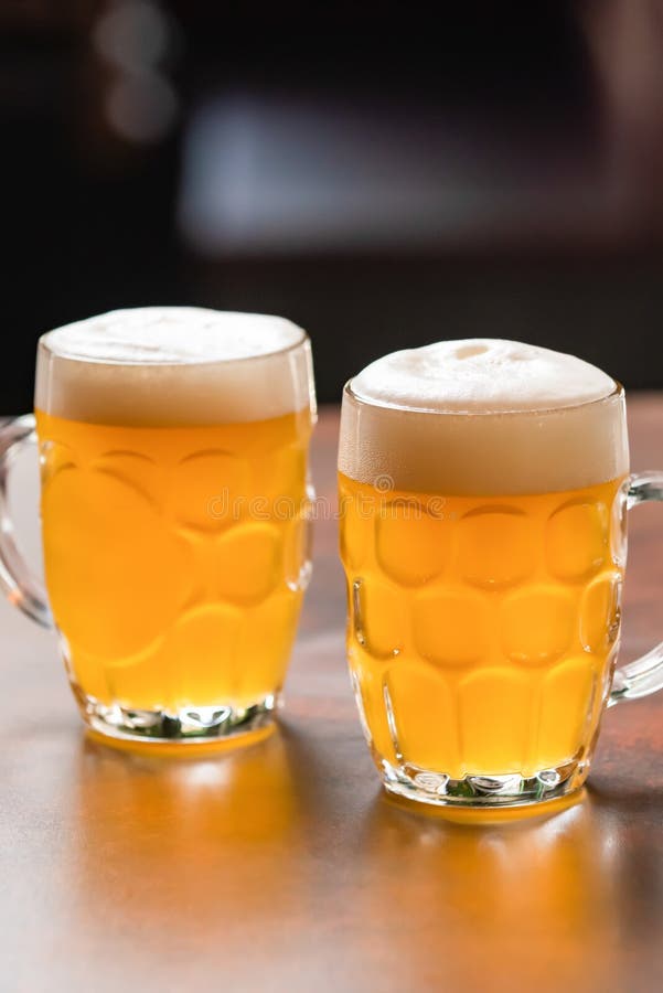 Two Mugs Full of Chopp, One with Pilsen Chopp and One with Dark Chop on ...