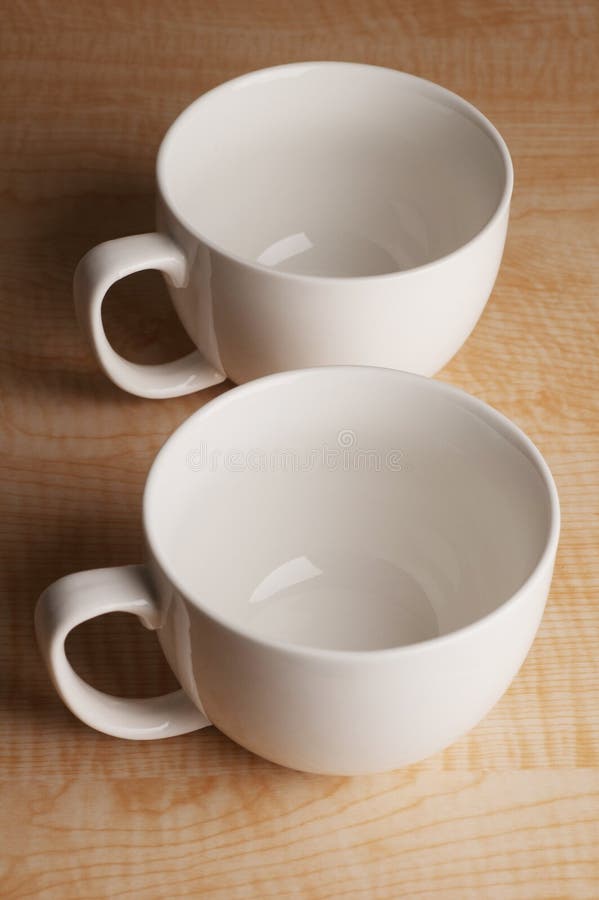 Two Mugs on Wooden Table stock photo. Image of mugs, porcelain - 24066136