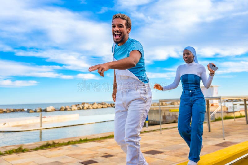 Two Multi-ethnic Friends Dancing Next To the Sea Stock Photo - Image of ...