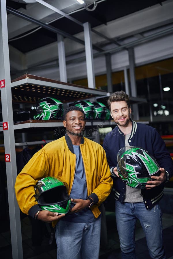 Two Multicultural Friends Holding Helmets and Stock Image - Image of ...