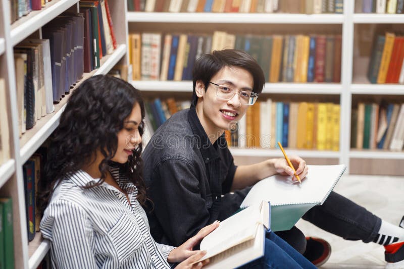 Two Multicultural Students Sitting on Floor at Library Stock Image ...