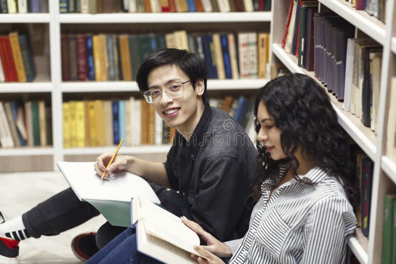 Two Multicultural Students Sitting on Floor at Library Stock Image ...