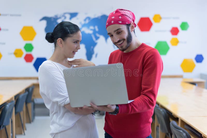 Two Multietchnic College Students Standing Inside Classroom and Using ...