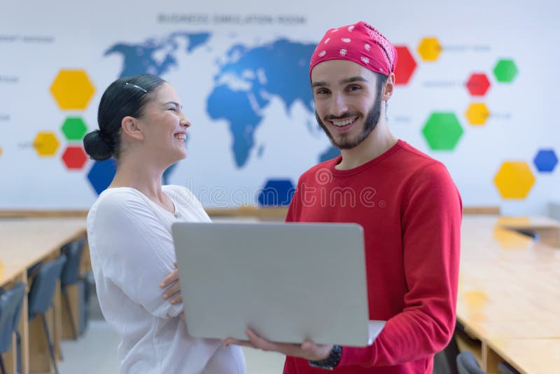 Two Multietchnic College Students Standing Inside Classroom and Using ...