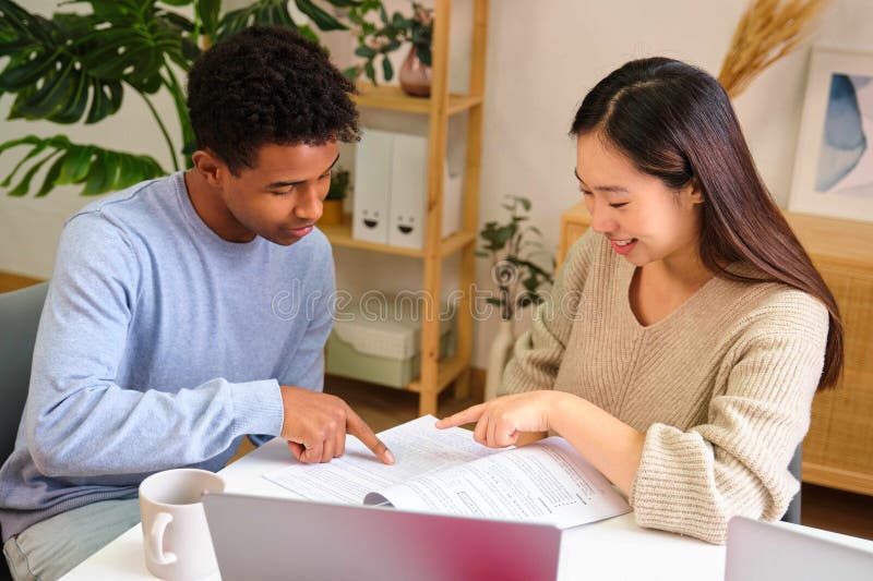 Two Multiethnic University Colleagues Studying Together at Shared ...