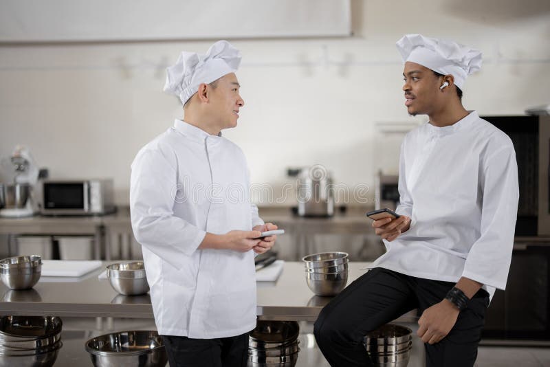 Two Multiracial Chef Cooks Talking during a Break at the Professional ...