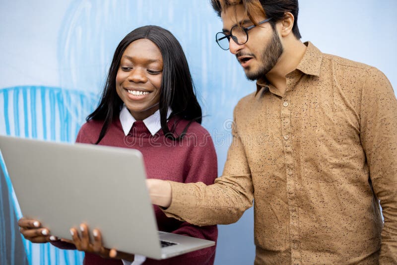 Two Multiracial Students Watch Some on Laptop Stock Photo - Image of ...