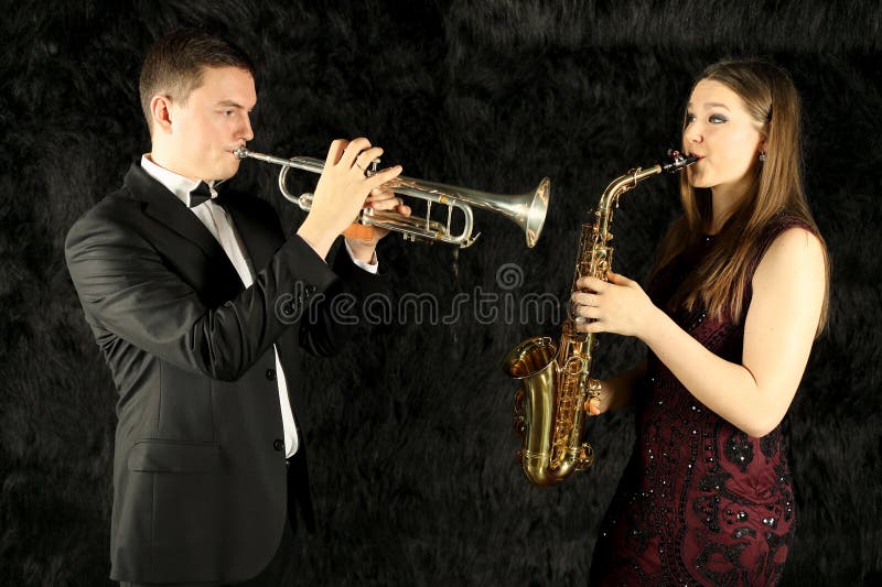 Two Musicians Playing on Wind Instruments on a Stock Photo - Image of ...
