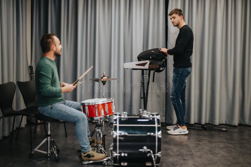 Musicians Preparing for a Band Practice with Drums and Keyboard Stock ...