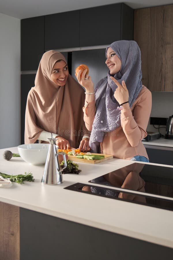 Two Muslim Women Preparing a Salad at Modern Kitchen. Stock Photo ...