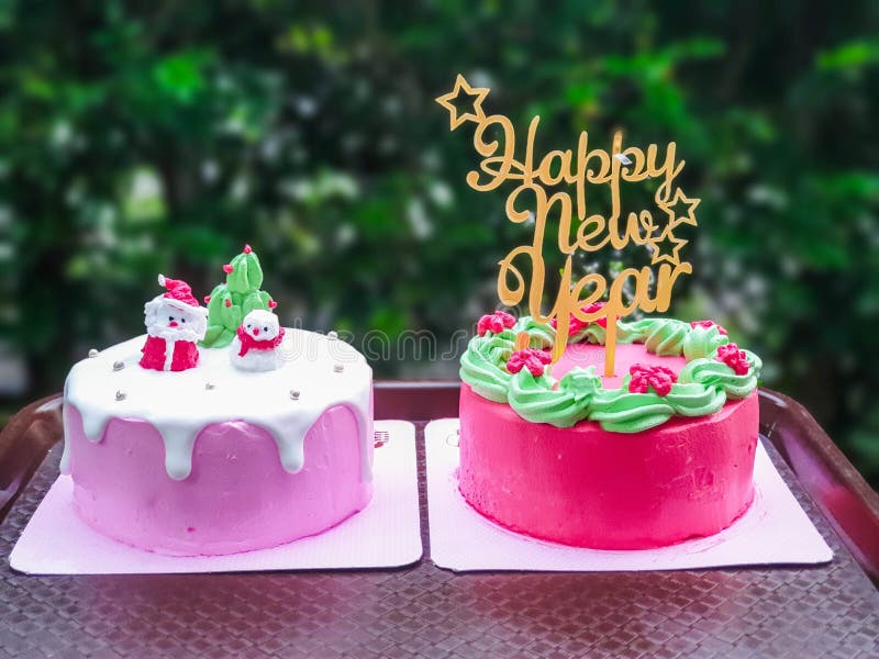Two New Year Cake in Tray on Green Tree Background Stock Image - Image ...