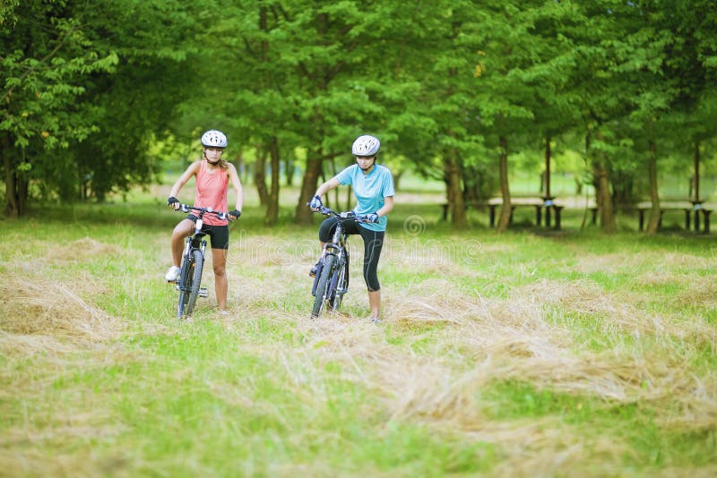 Two Nice Caucasian Girl Cycling Outside Stock Photo - Image of outdoors ...