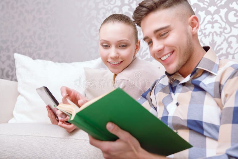 Two Nice Young People Reading Stock Image - Image of home, length: 53352887
