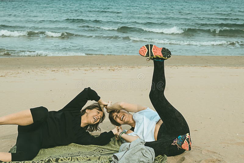 Normal Women on the Beach Smiling and Sitting on the Sand. Stock Photo ...