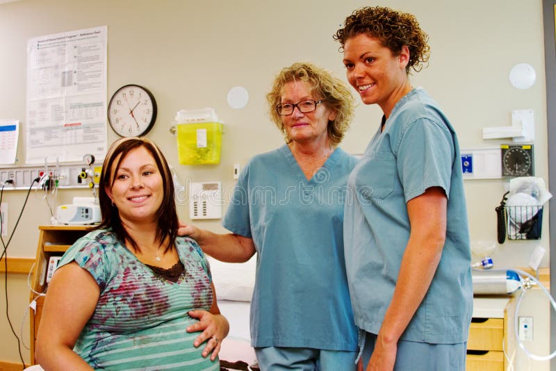 Two Nurses with Labor Patient Stock Photo - Image of parenthood, female ...