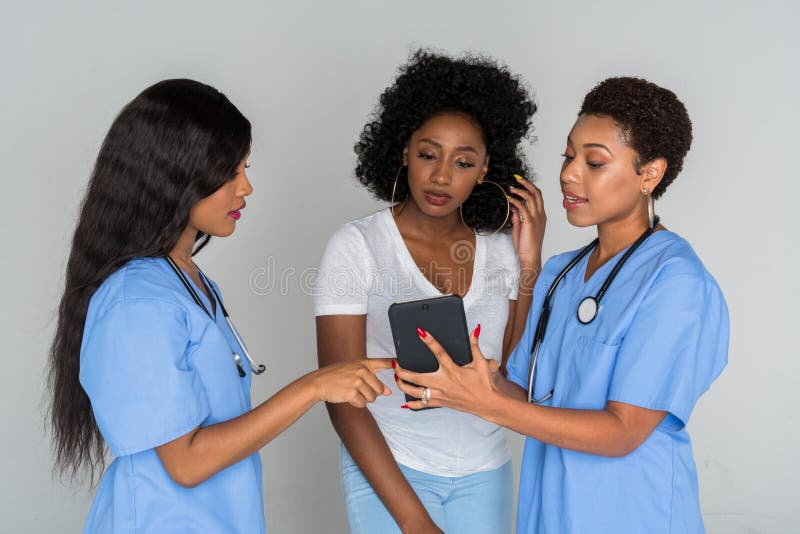 Two Nurses with Patient stock photo. Image of black - 118882142