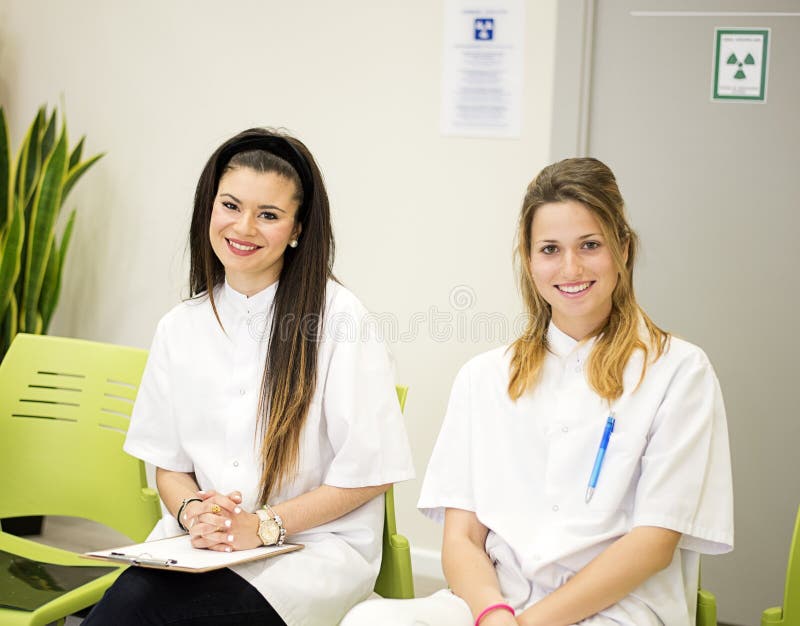 Two Nurses Smile at Camera in Hospital Stock Photo - Image of robe ...