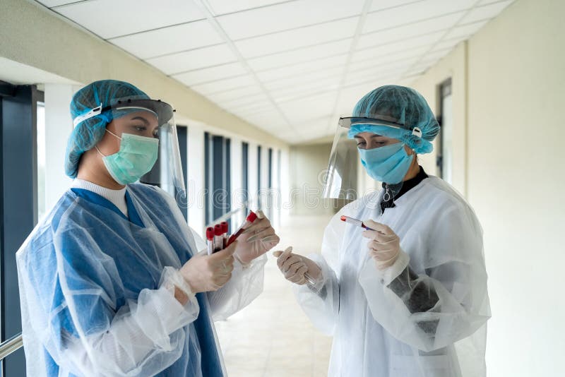 Two Nurses Work with Blood Samples To Determine the Outcome of a ...