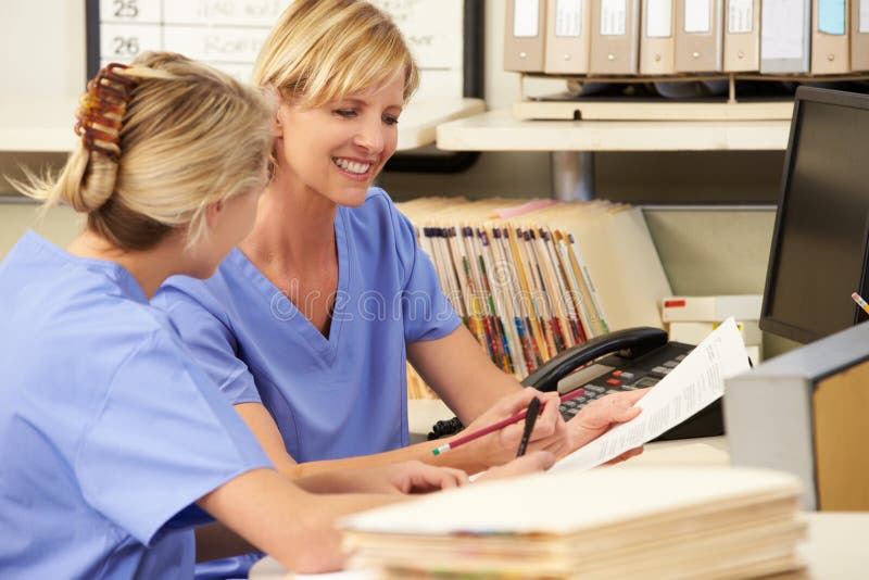 Two Nurses Working at Nurses Station Stock Image - Image of pretty ...