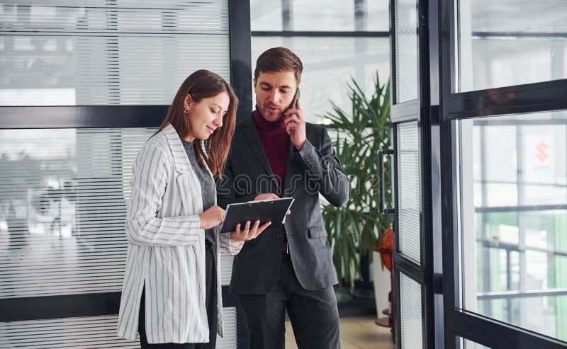 Two Office Workers in Formal Clothes Indoors Have a Busy Working Day ...
