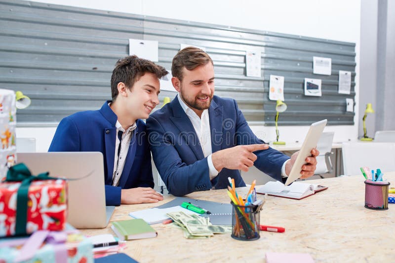 Two Office Workers Look at the Tablet Where One of Them Points with a ...