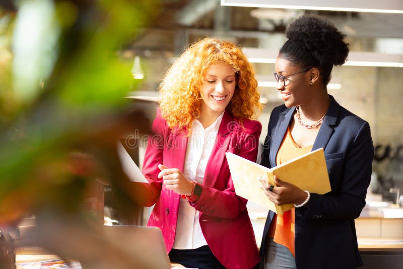Two Office Workers Smiling while Working Together Stock Photo - Image ...