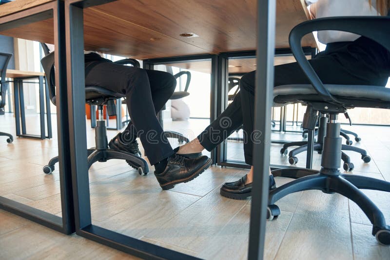 Two Office Workers Touching Legs Under The Table Romantic Stock Image