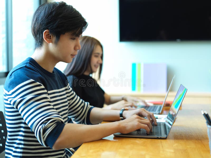 Two Office Workers Working with Laptops on Meeting Table Stock Image ...