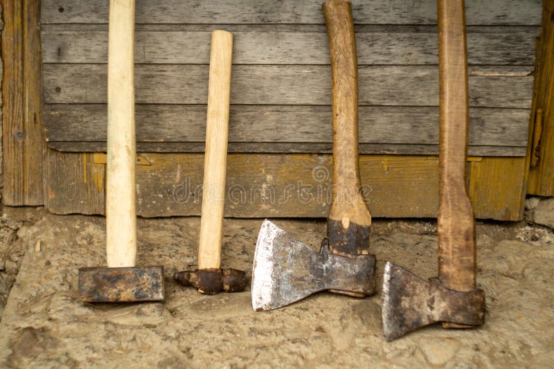 Two Old Axes, a Hammer and a Sledge Near a Wooden Wall Stock Image ...