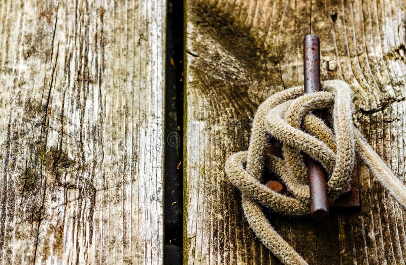 Two Old Dock Boards with an Old Rope Tied To a Rusty Cleat Stock Image ...