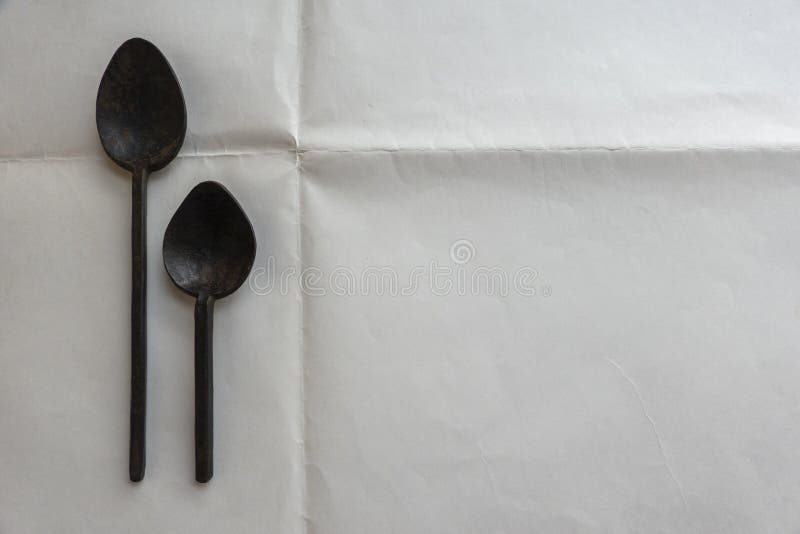 Two Old Iron Spoons on White Background with a Copy Space on the Right ...