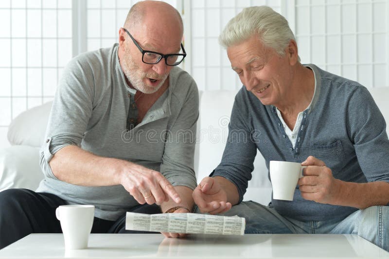 Two Old Men Sitting at Table and Discussing News Stock Photo - Image of ...