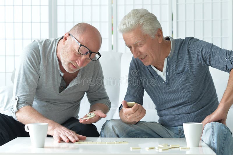 Two Old Men Sitting at Table and Playing Domino Stock Photo - Image of ...